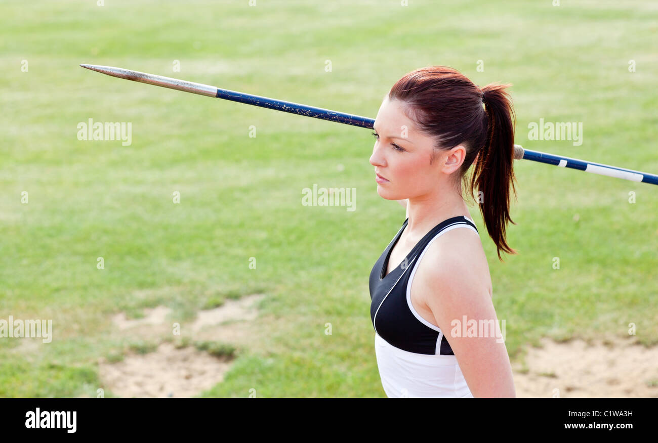 Concentrated female athlete ready to throw javelin Stock Photo - Alamy