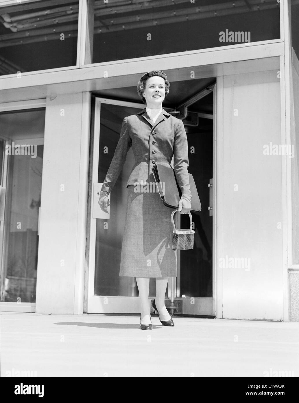 Woman outside building Stock Photo - Alamy