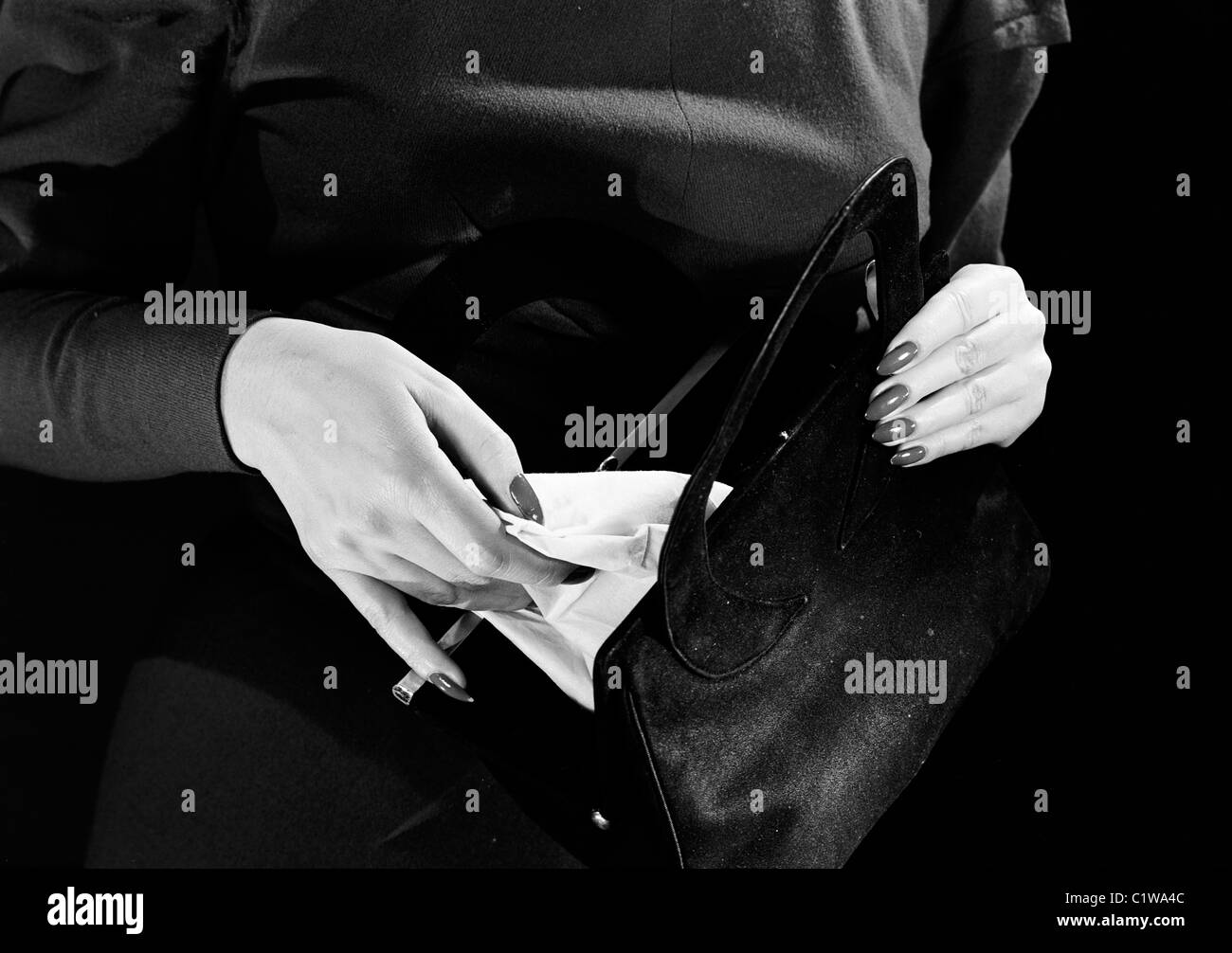 Woman taking tissue from bag Stock Photo - Alamy