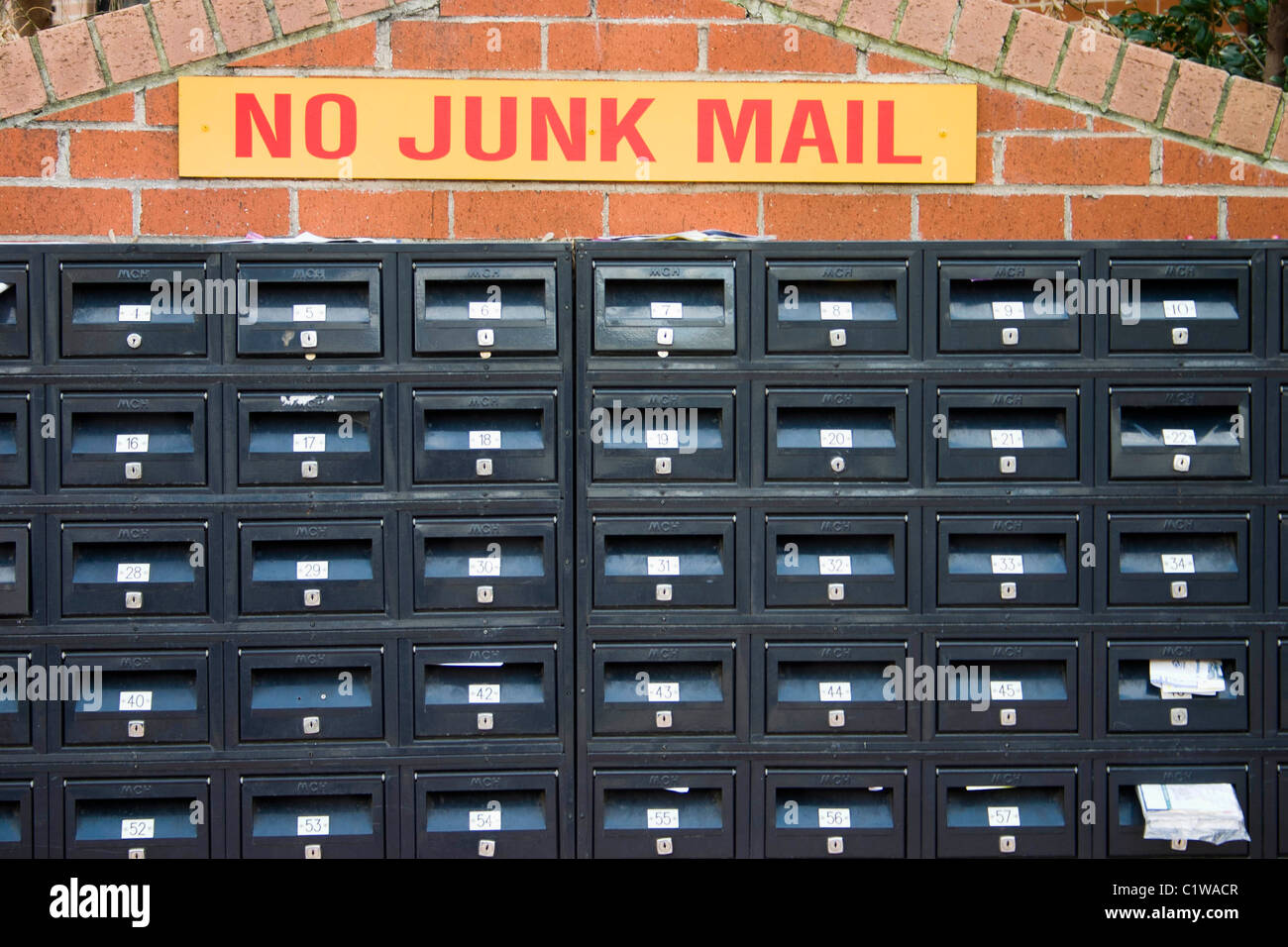 Rows of letterboxes and a No Junk Mail sign Stock Photo - Alamy