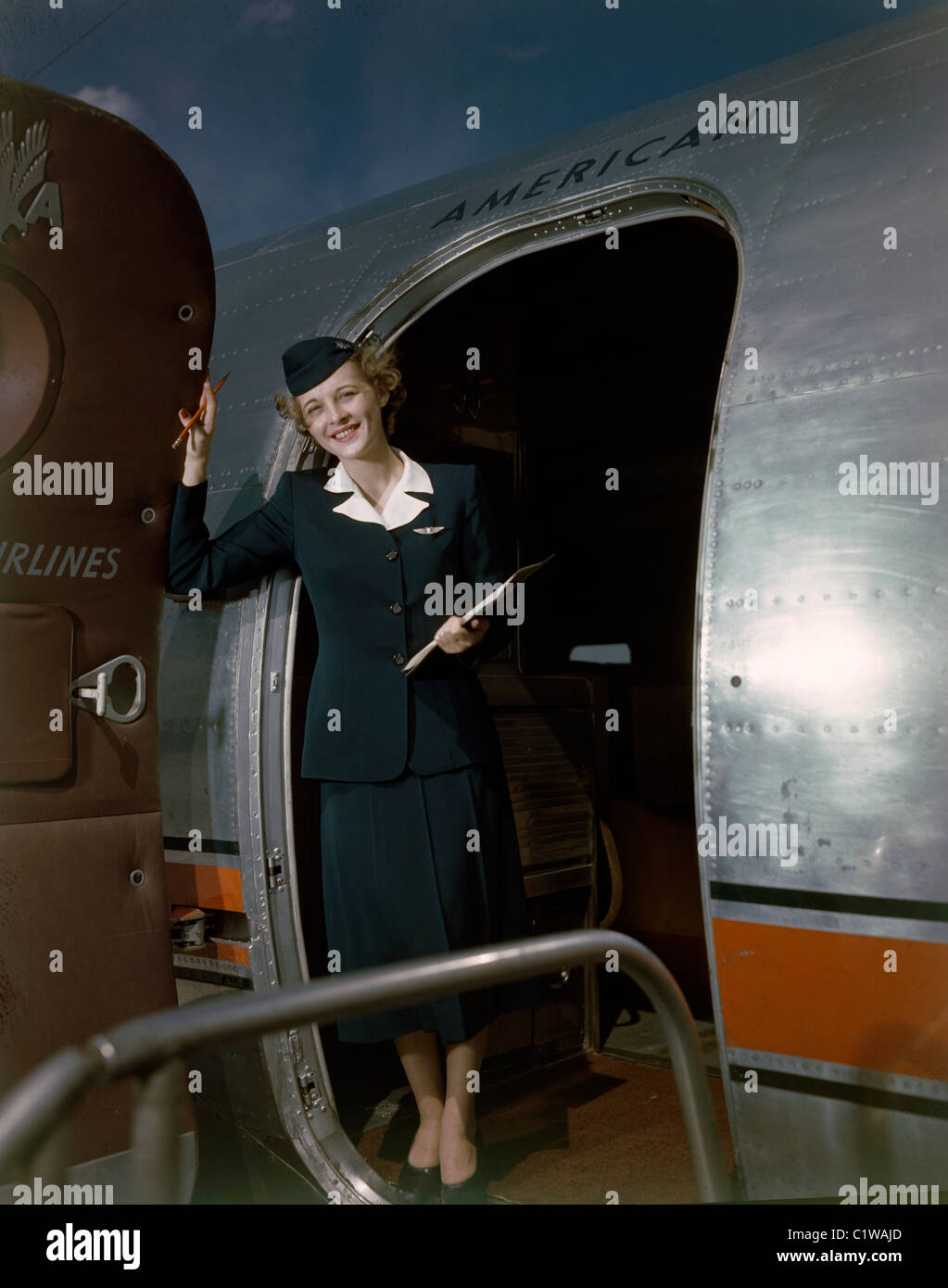 Airline hostess standing in doorway of plane Stock Photo - Alamy
