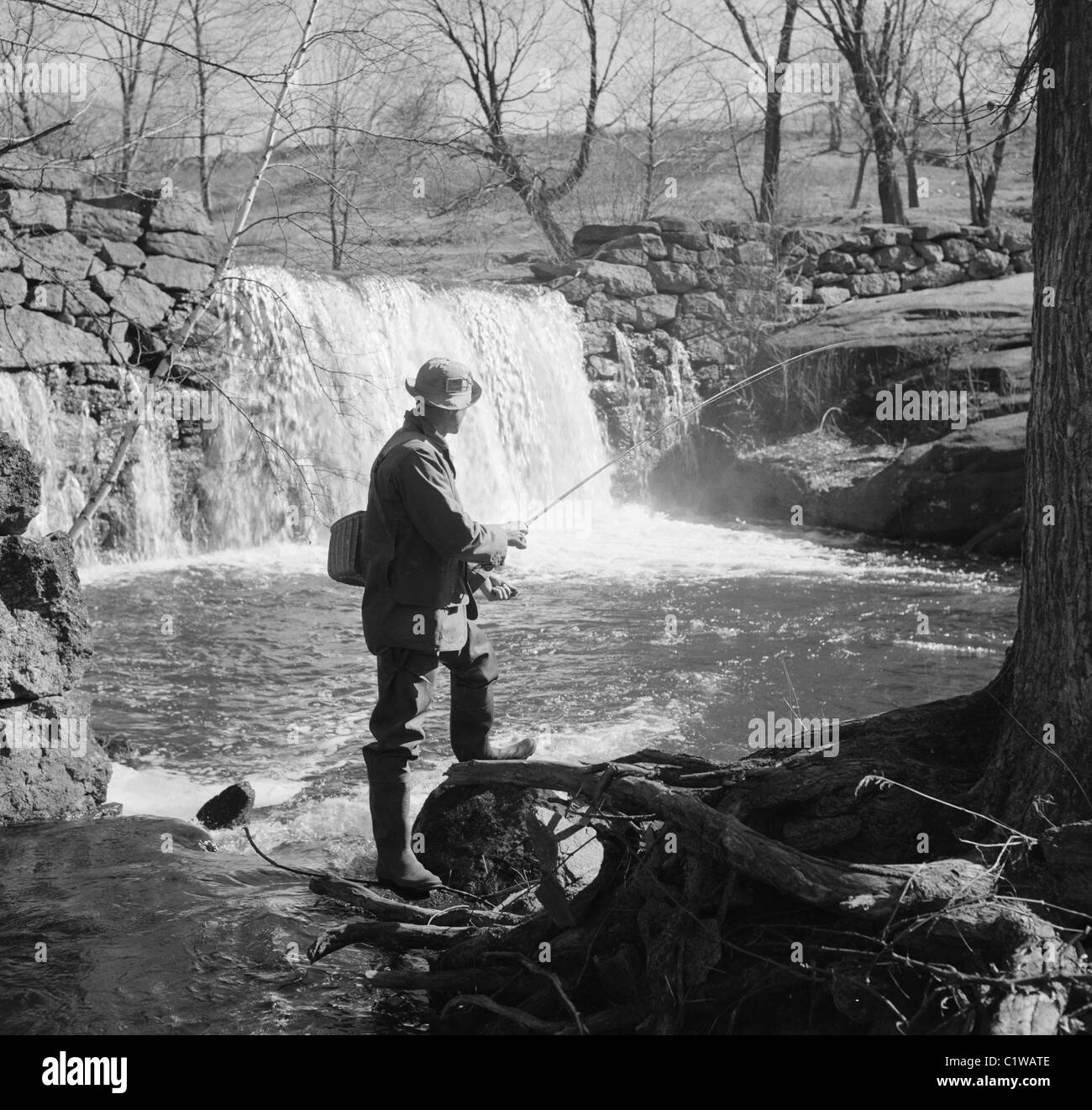 Man fly fishing in black Black and White Stock Photos & Images - Alamy