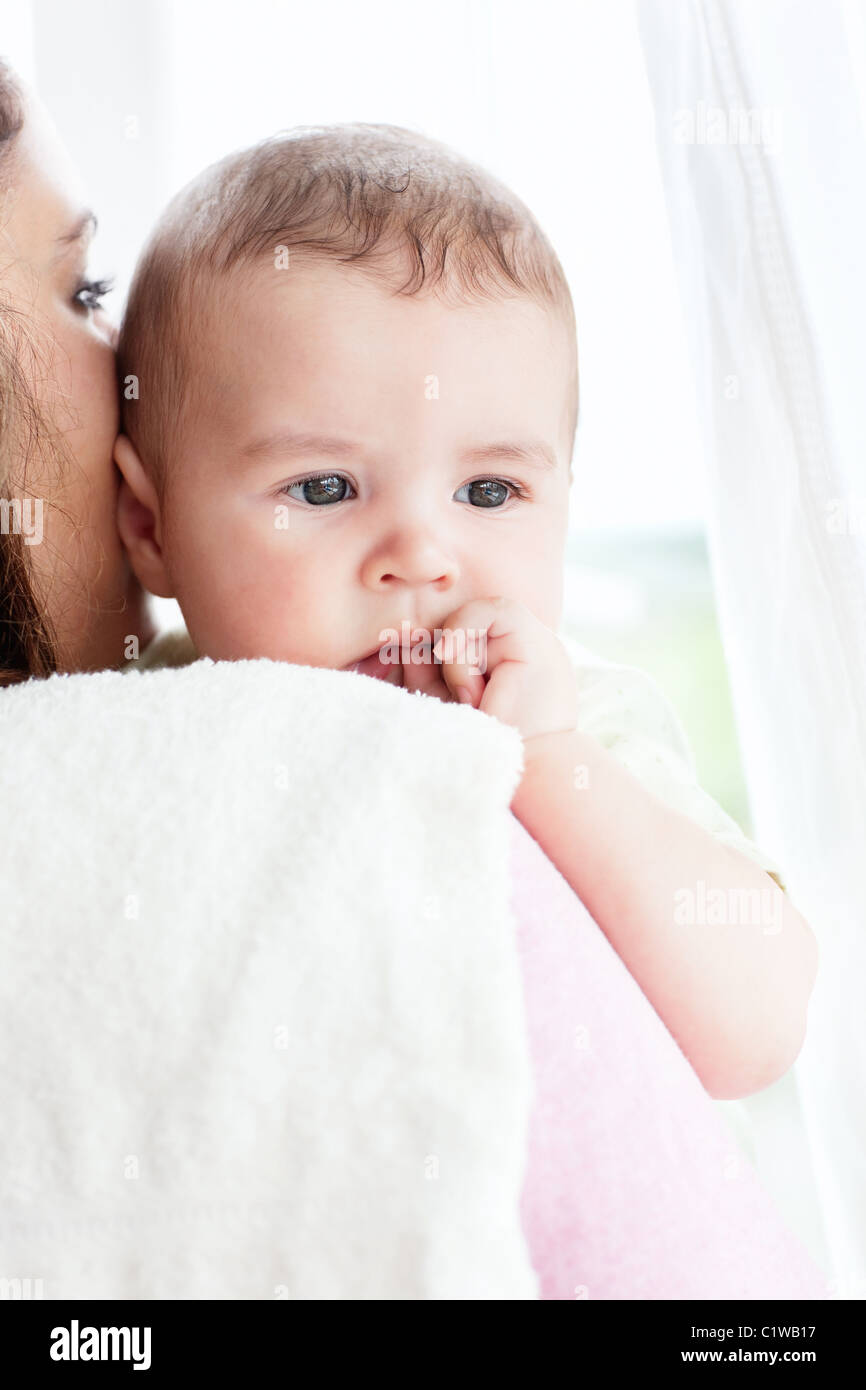 Kind mother taking care of her adorable baby Stock Photo - Alamy