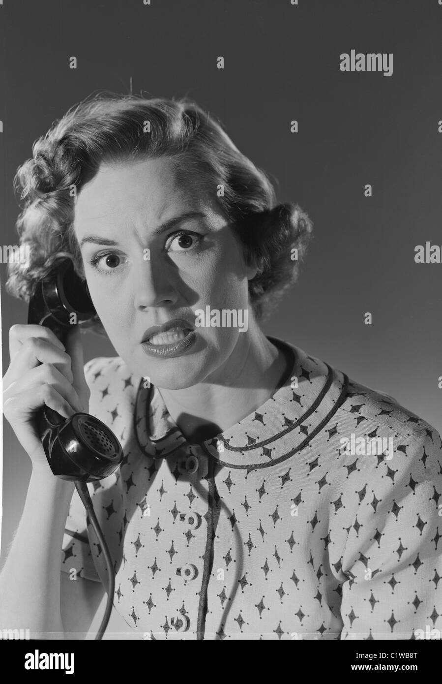 Studio portrait of young woman talking on phone Stock Photo - Alamy
