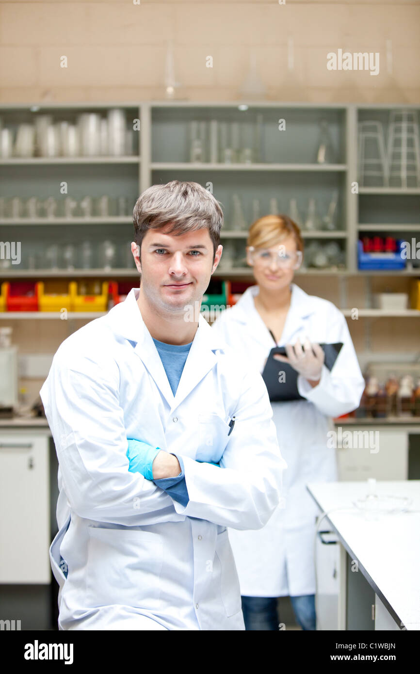 Two serious scientists looking at the camera standing Stock Photo - Alamy