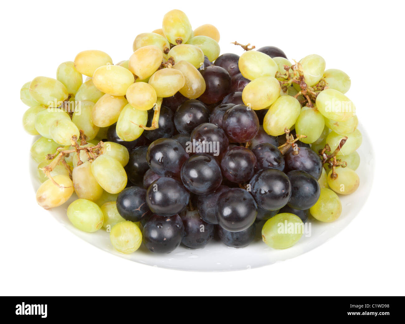 Plate with ripe grape insulated on white background Stock Photo - Alamy