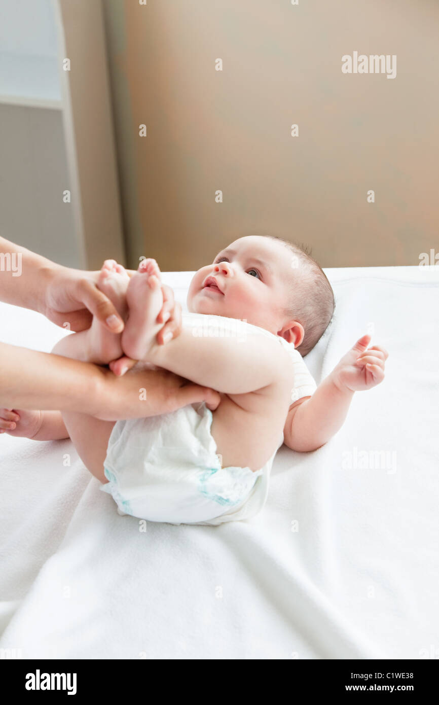 Close-up of a mother changing the nappy of her baby Stock Photo - Alamy