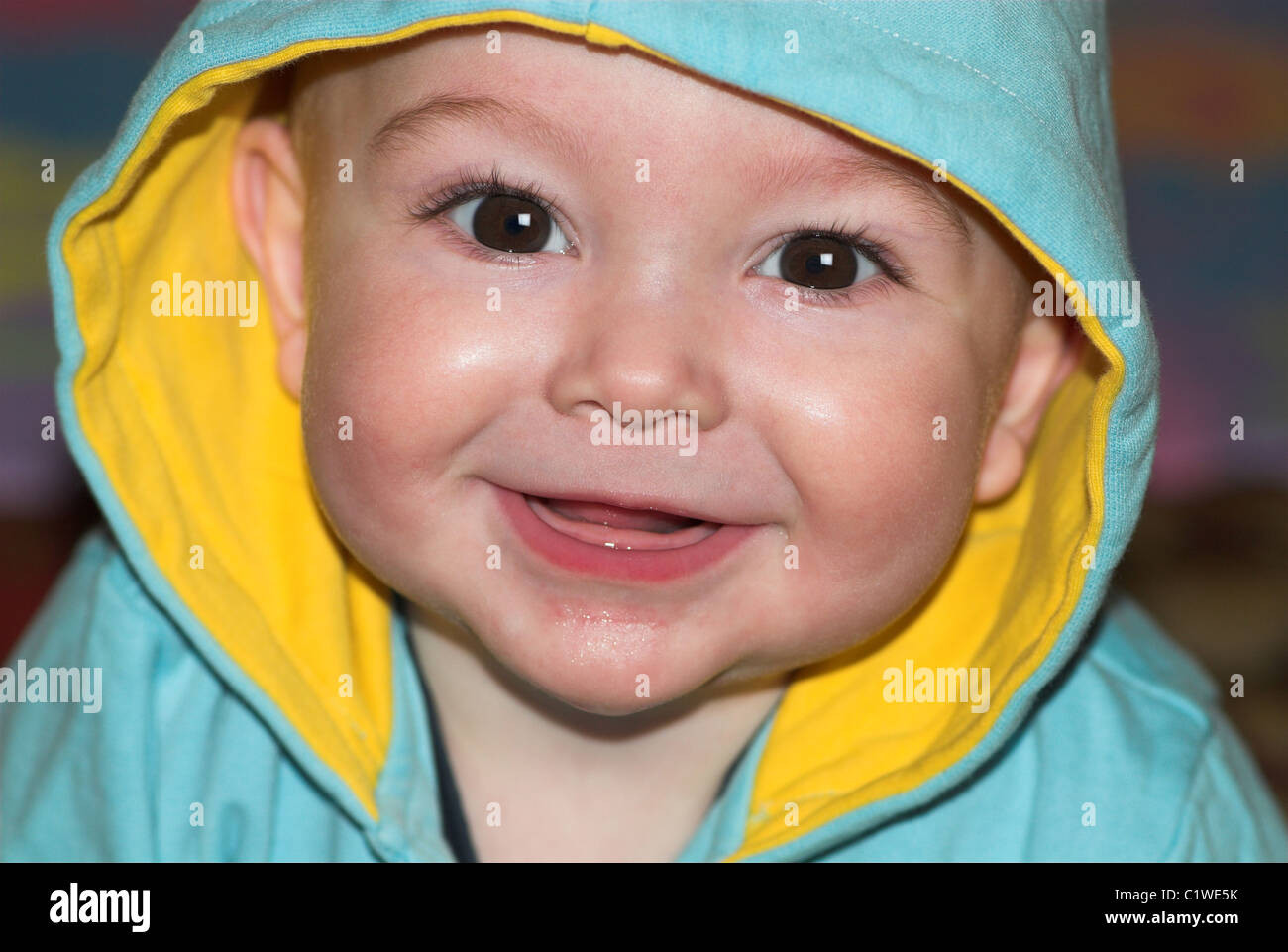 Cute toothless baby with hood on his head Stock Photo - Alamy