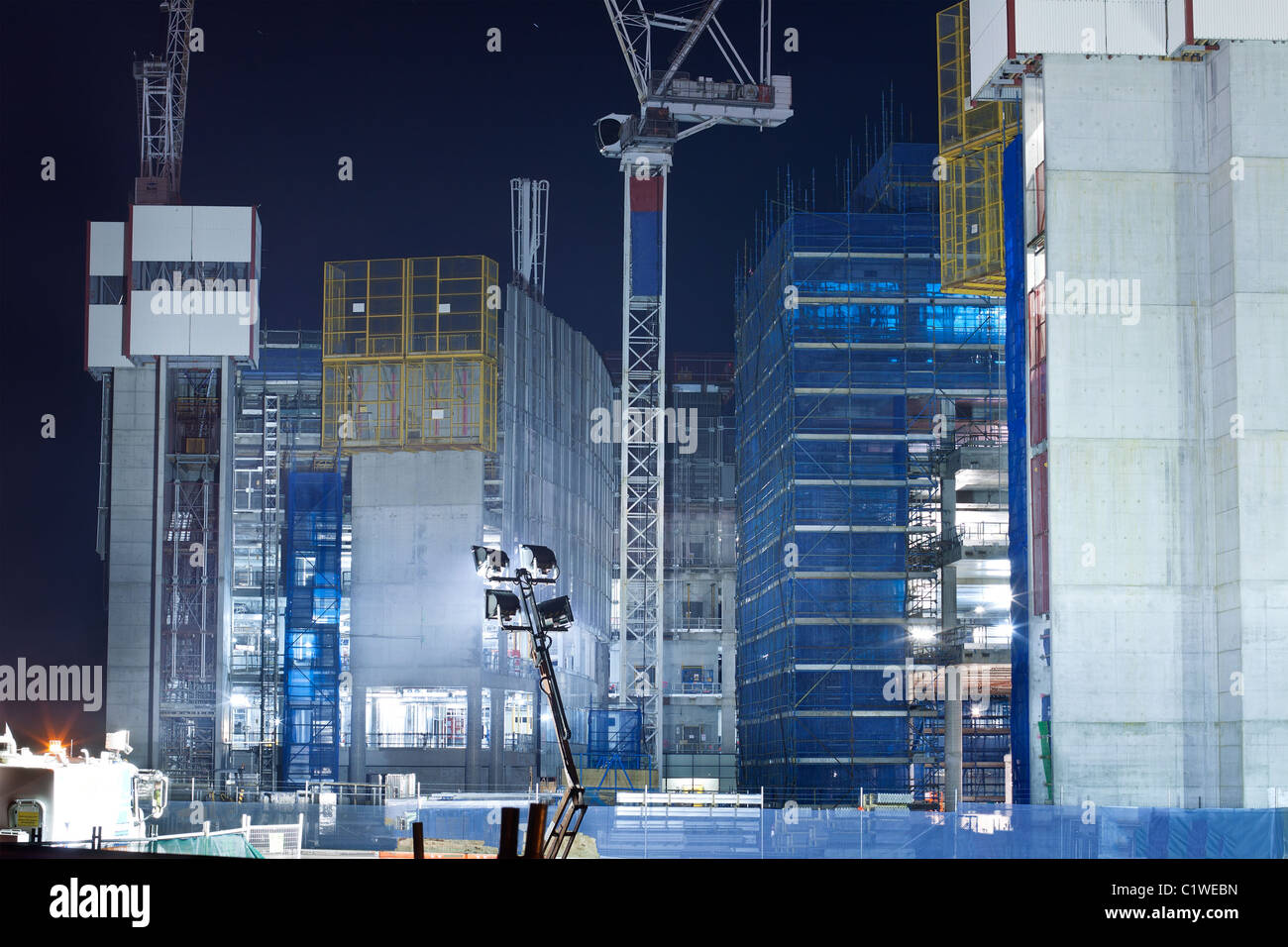 Screen system and scaffold on the construction building at night (gold ...