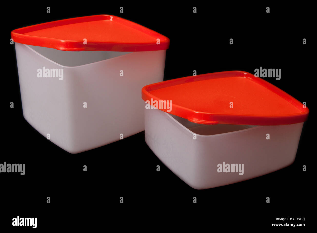 Two white translucent plastic containers with red lid insulated on ...