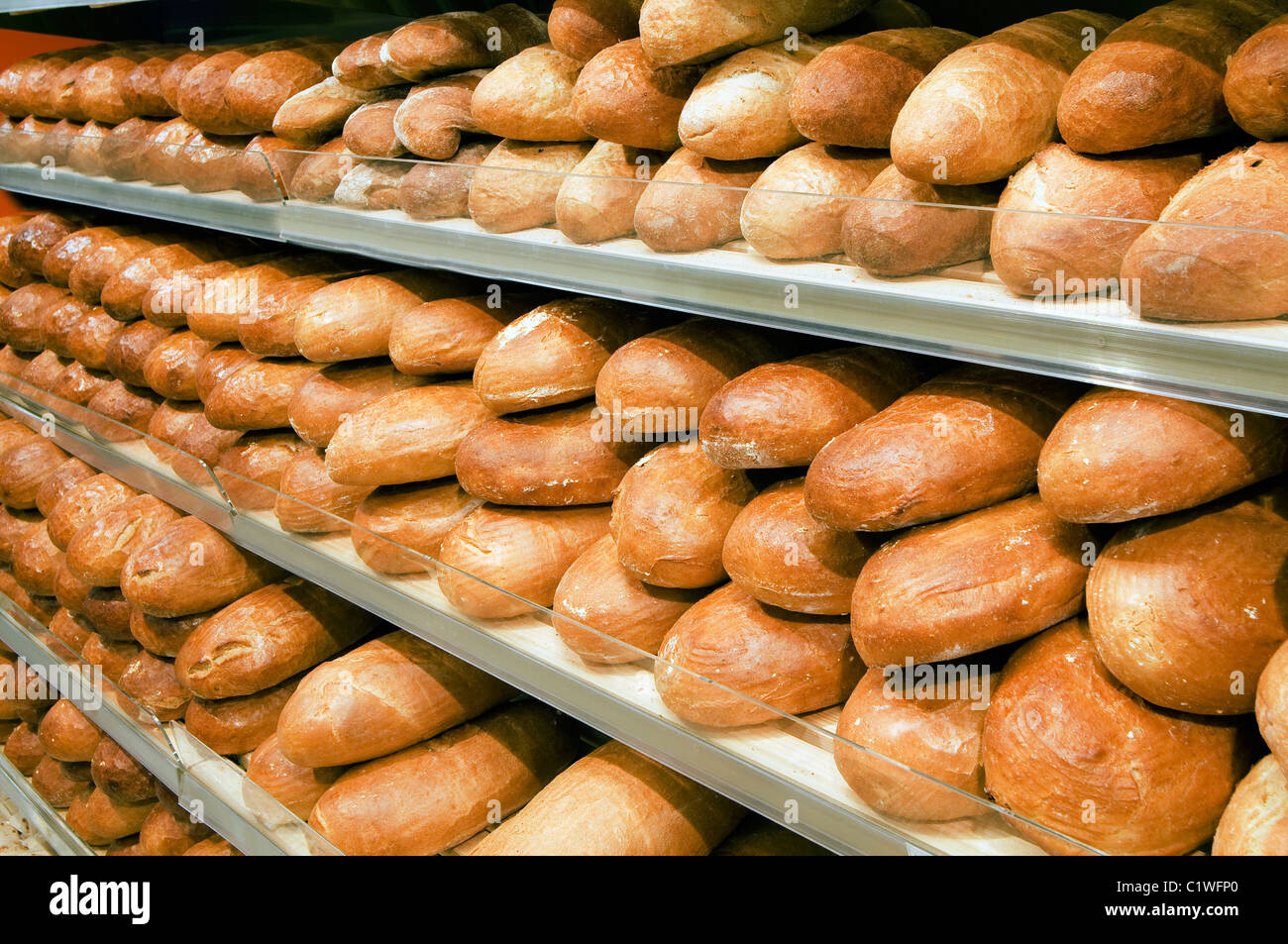 Loaves of bread on shelves in a store Stock Photo - Alamy