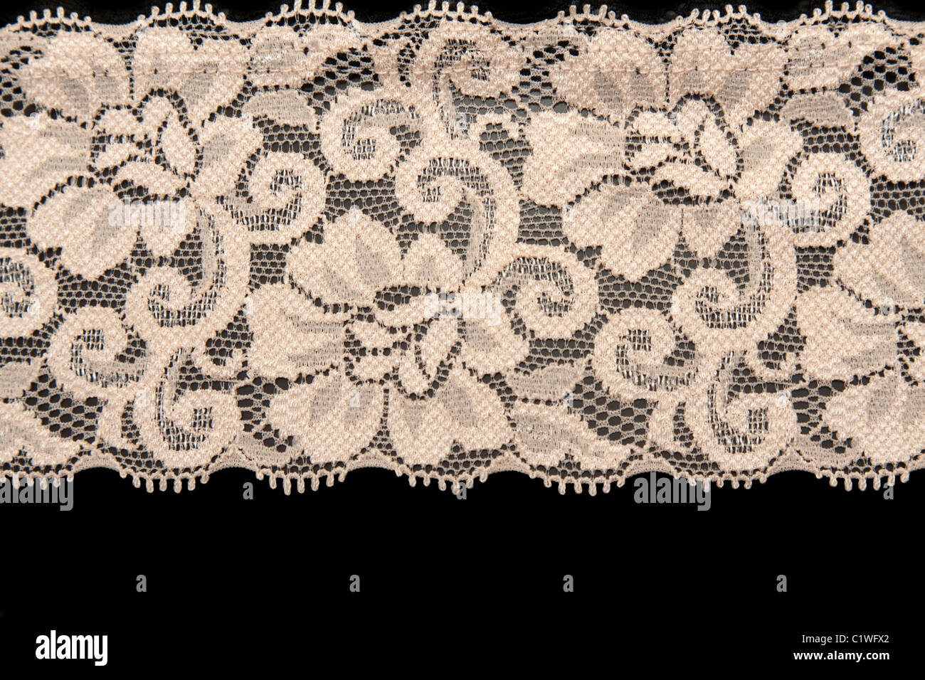 Beige lace with pattern flower on black background Stock Photo - Alamy