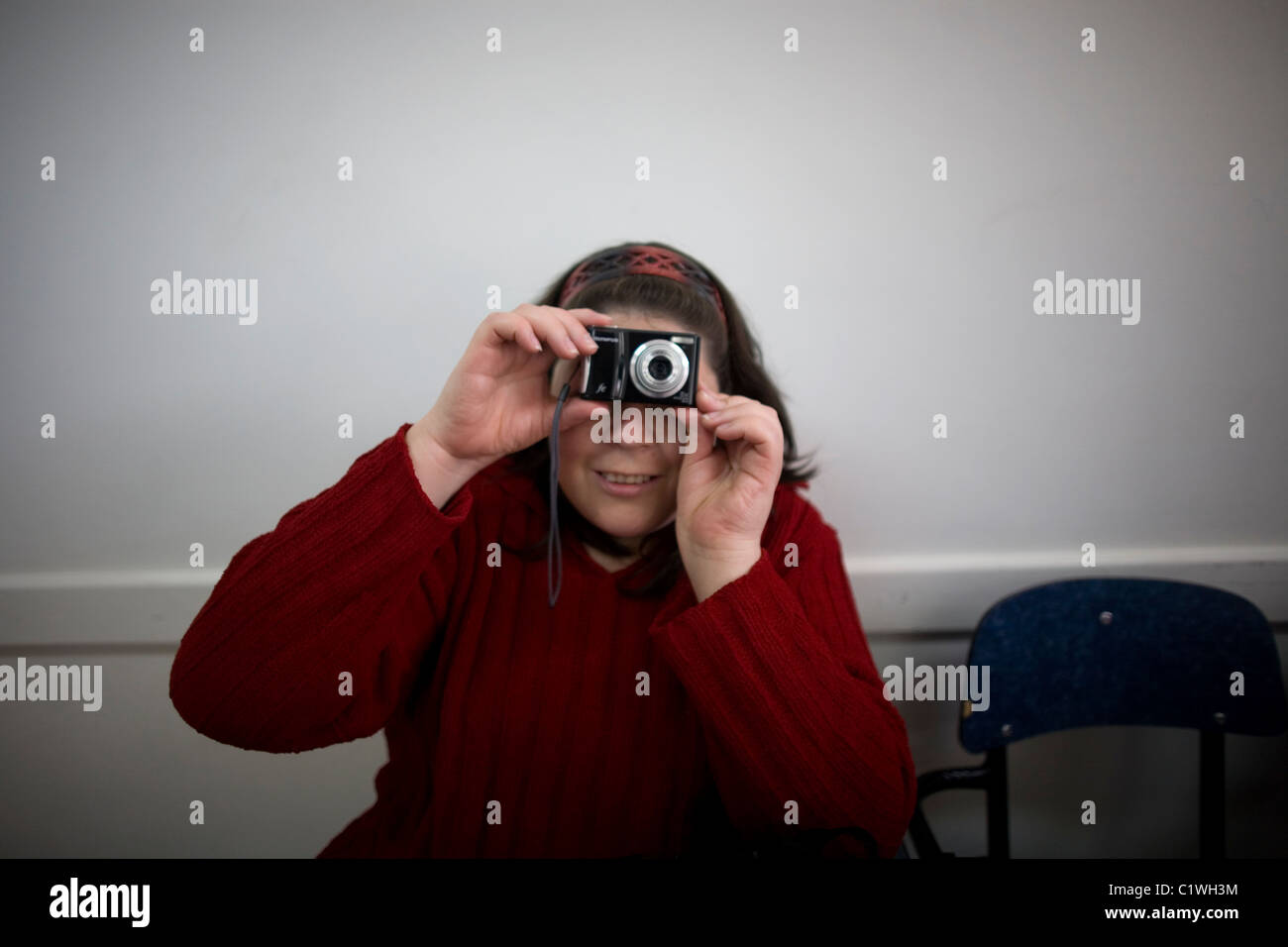 A blind student takes a picture during a photography workshop for the ...