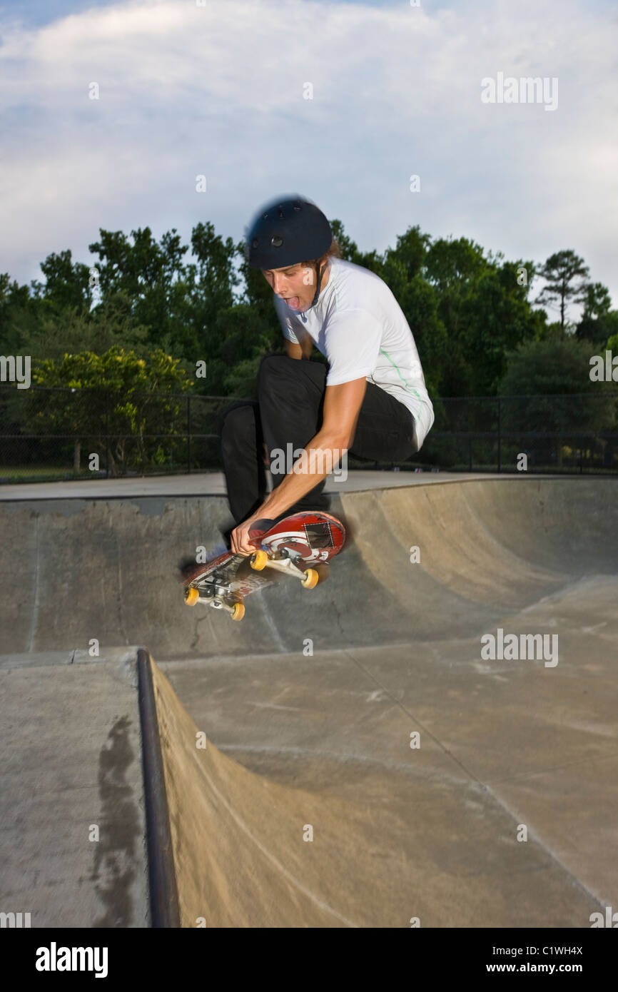 Male skateboarder jumping from ramp at skateboard park Stock Photo - Alamy