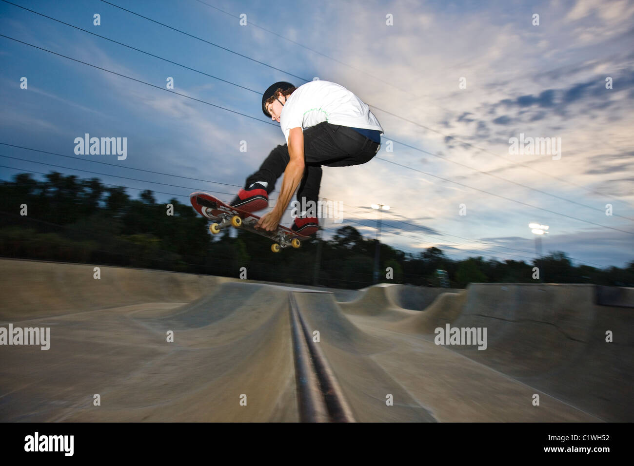 Male skateboarder jumping from ramp at skateboard park Stock Photo - Alamy