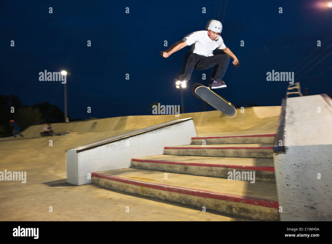 Male skateboarder jumping from ramp at skateboard park Stock Photo - Alamy