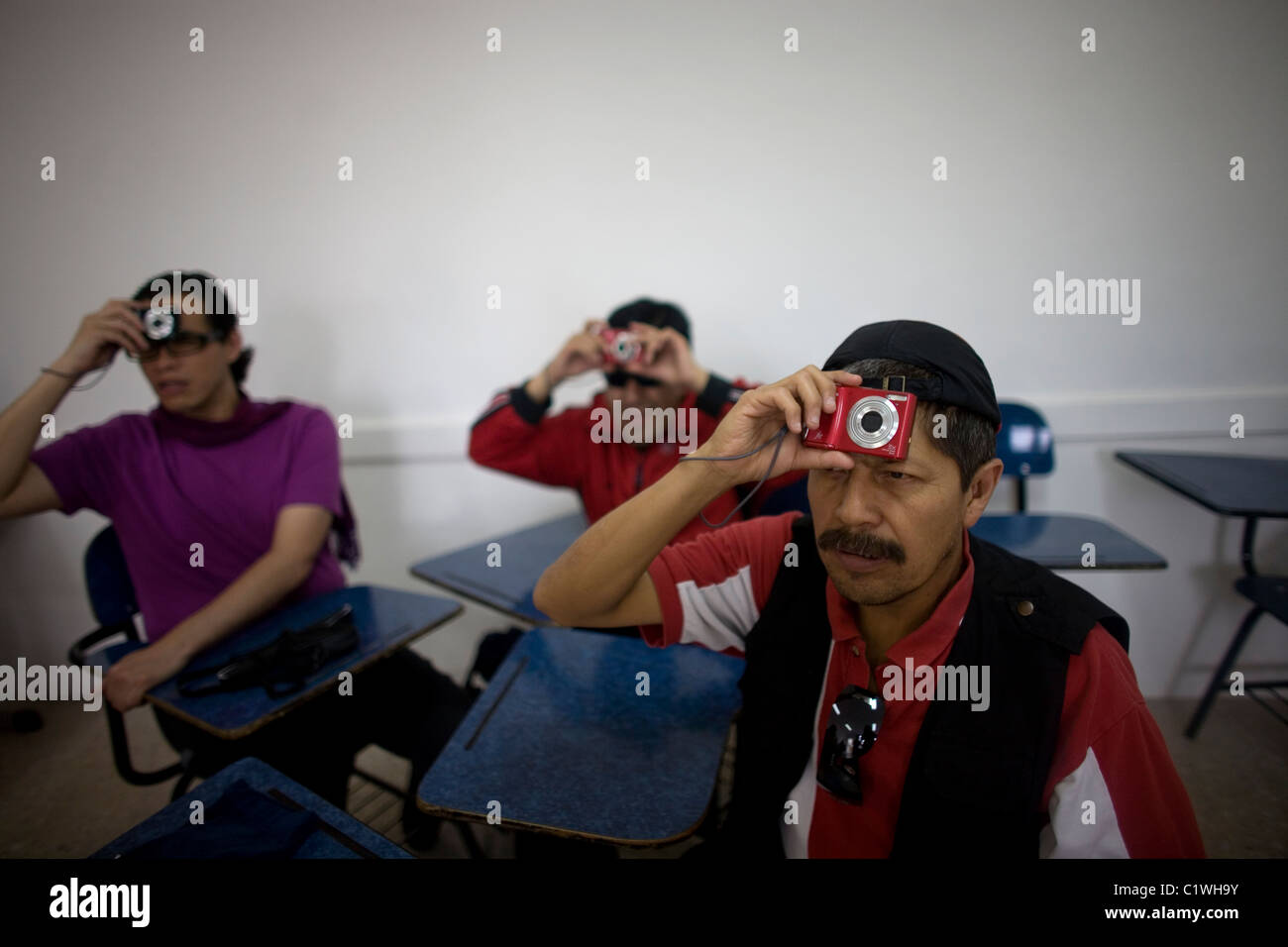 Blind and visually impaired students take pictures at a photography ...