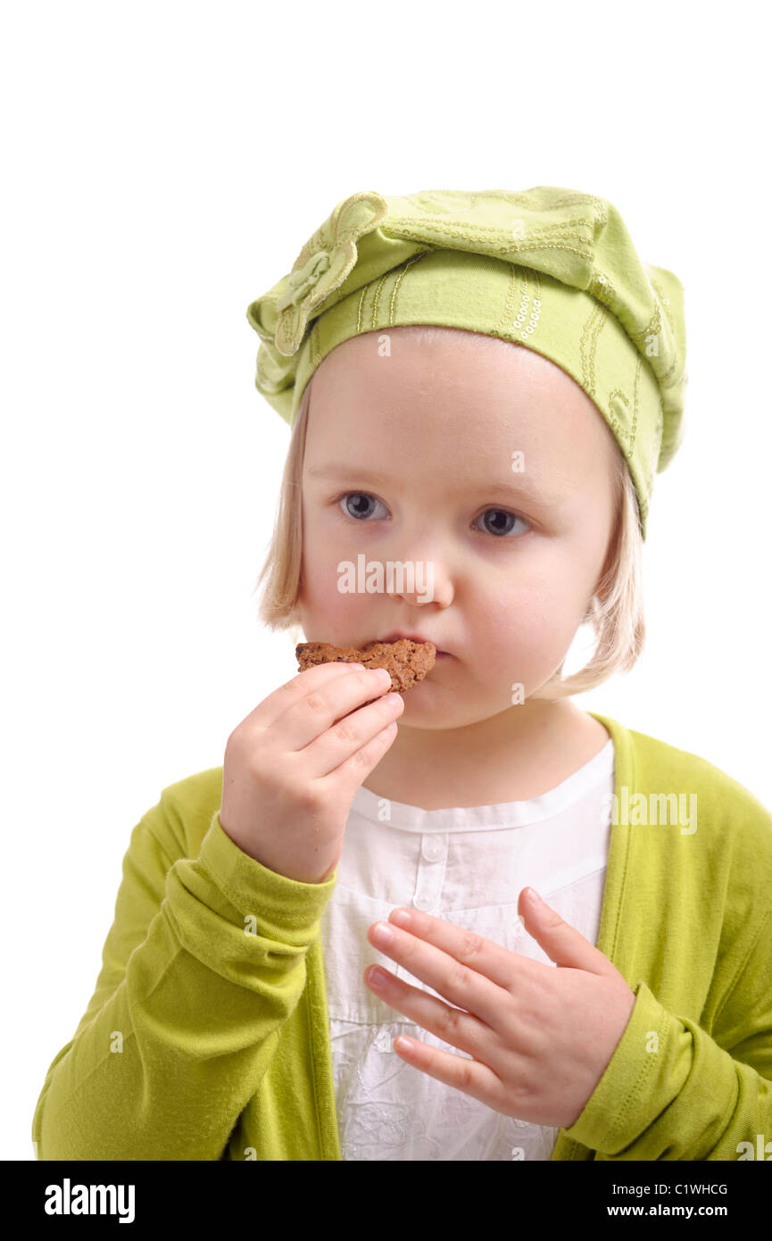 cute little girl eating a cookie. Isolated on white background Stock ...