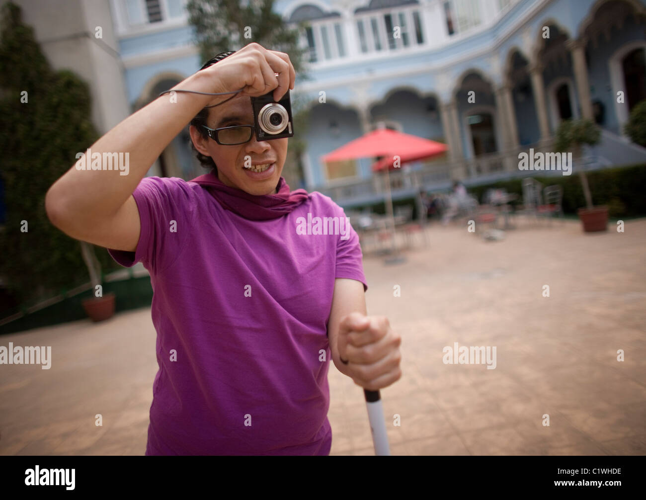 A visually impaired student takes pictures during a photography ...