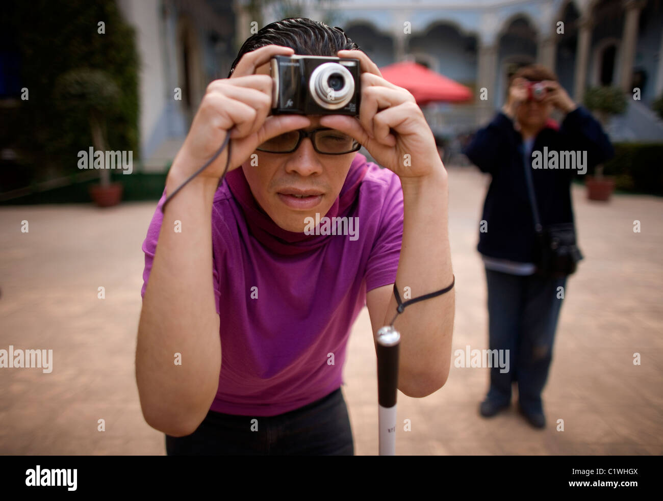 Visually impaired and blind students take pictures at a photography ...