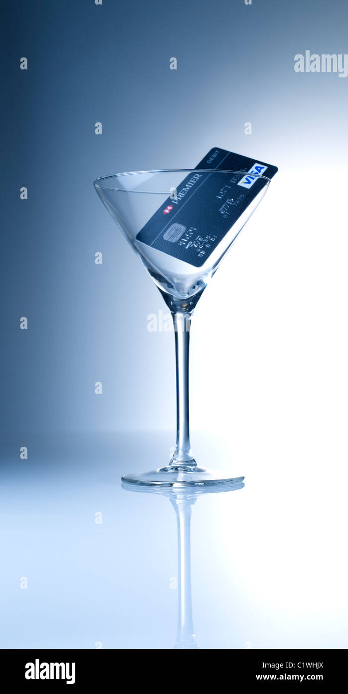 Cocktail glass and debit credit card Stock Photo - Alamy