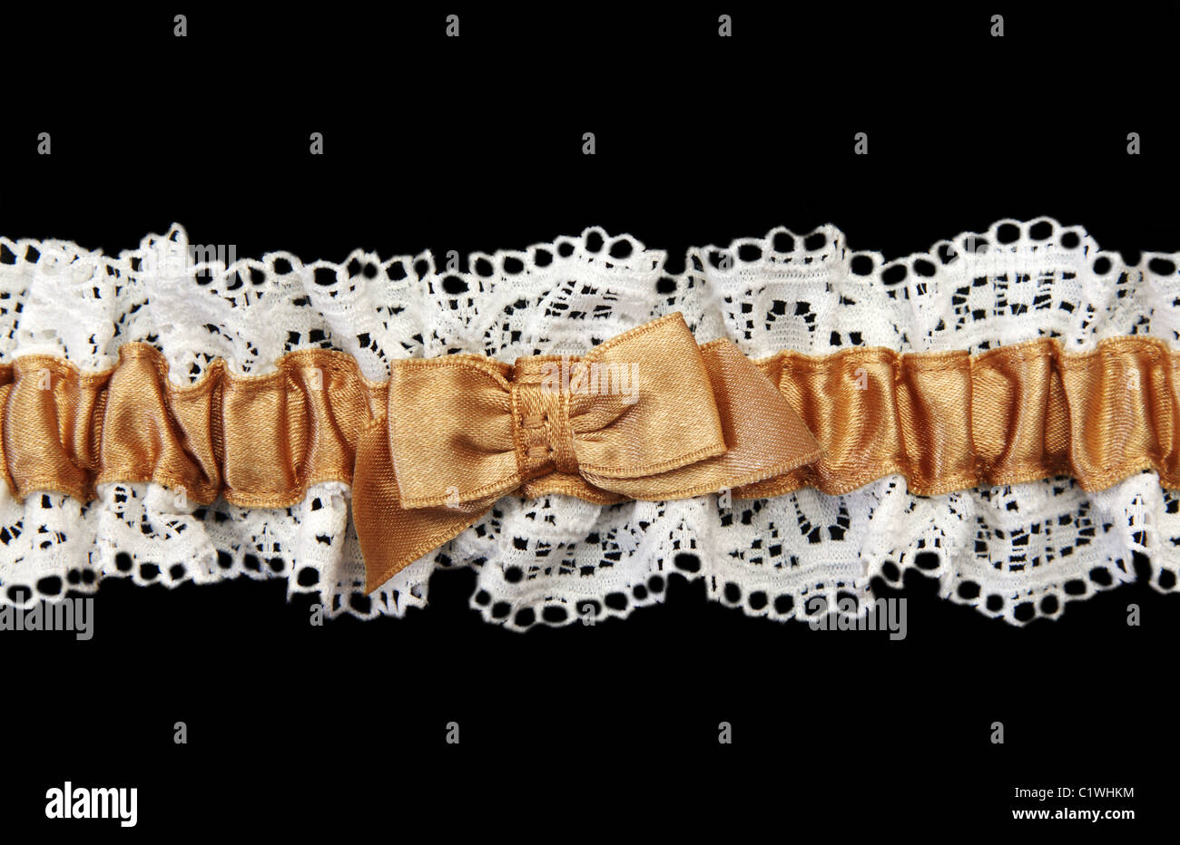 Blanching feminine garter with beige satin band on black background ...