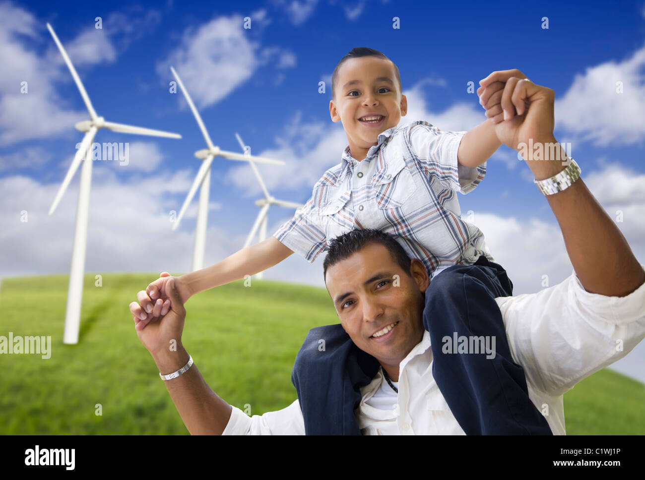 Happy Hispanic Father and Son with Wind Turbine Farm Over Blue Sky ...
