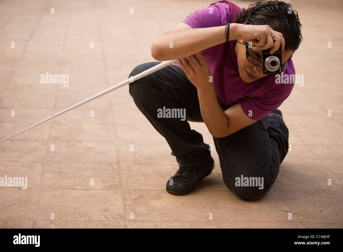 A visually impaired photographer takes pictures during a photography ...