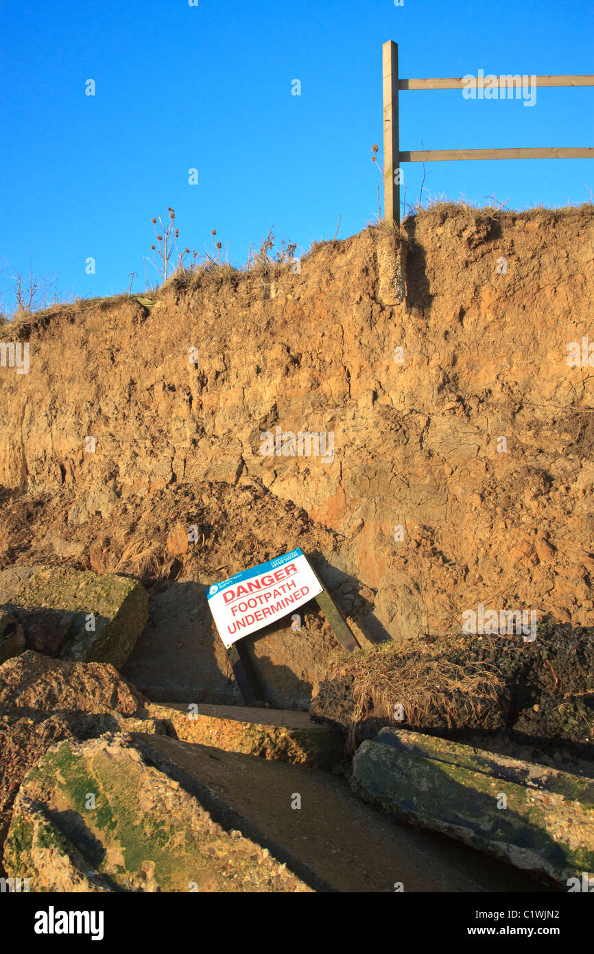 A warning sign at the bottom of a collapsed cliff Stock Photo - Alamy
