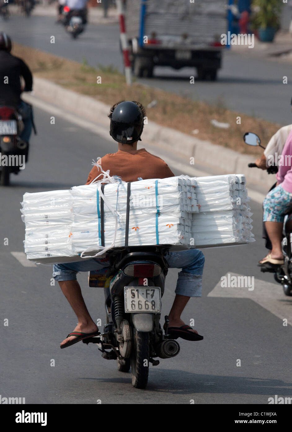 Man on Motorcycle with Large Load Stock Photo - Alamy