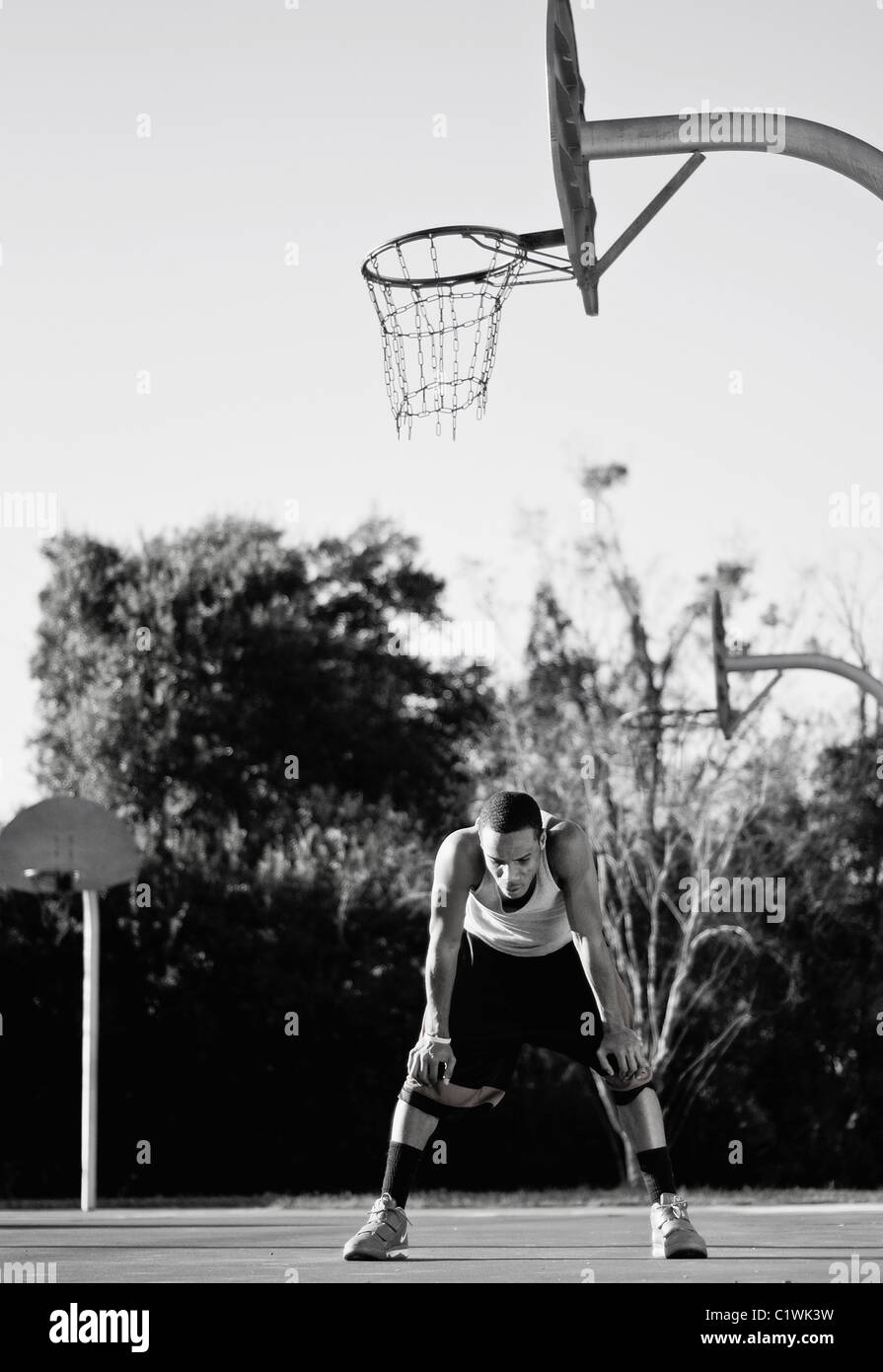 Basketball player looking tired in a court Stock Photo - Alamy