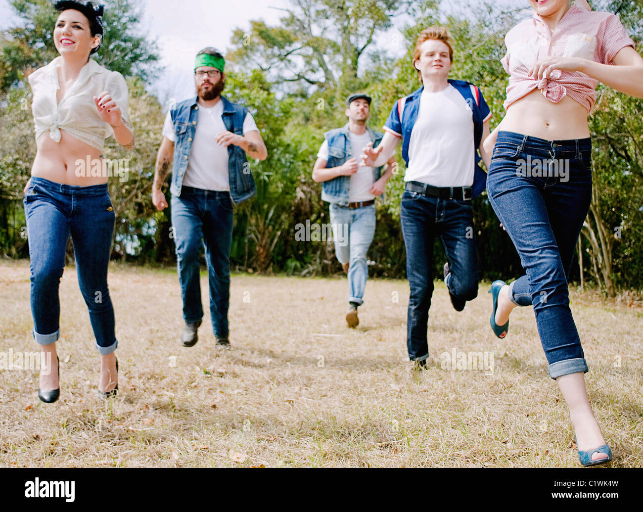 Friends running in a park Stock Photo - Alamy