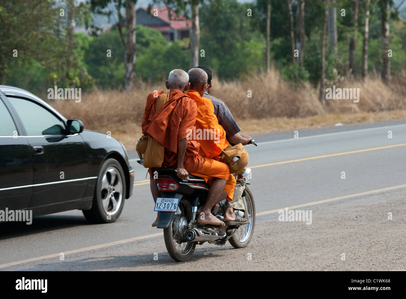 Two Cambodian Monks getting a ride on a Motorcycle Stock Photo - Alamy