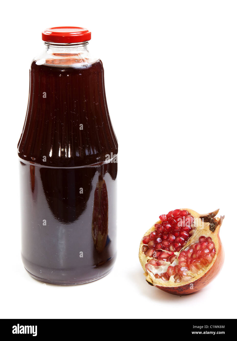 Bottle of juice and ripe piece grenade on white background Stock Photo ...