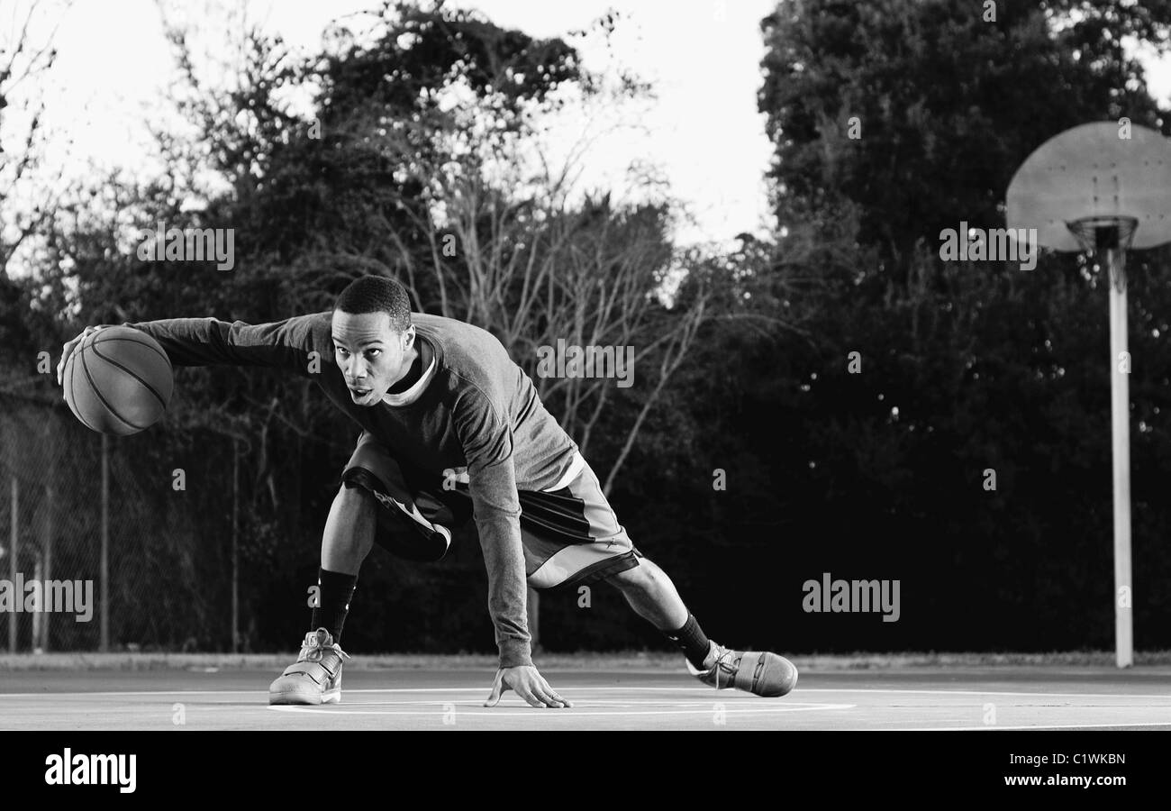 Basketball player practicing in a court Stock Photo - Alamy