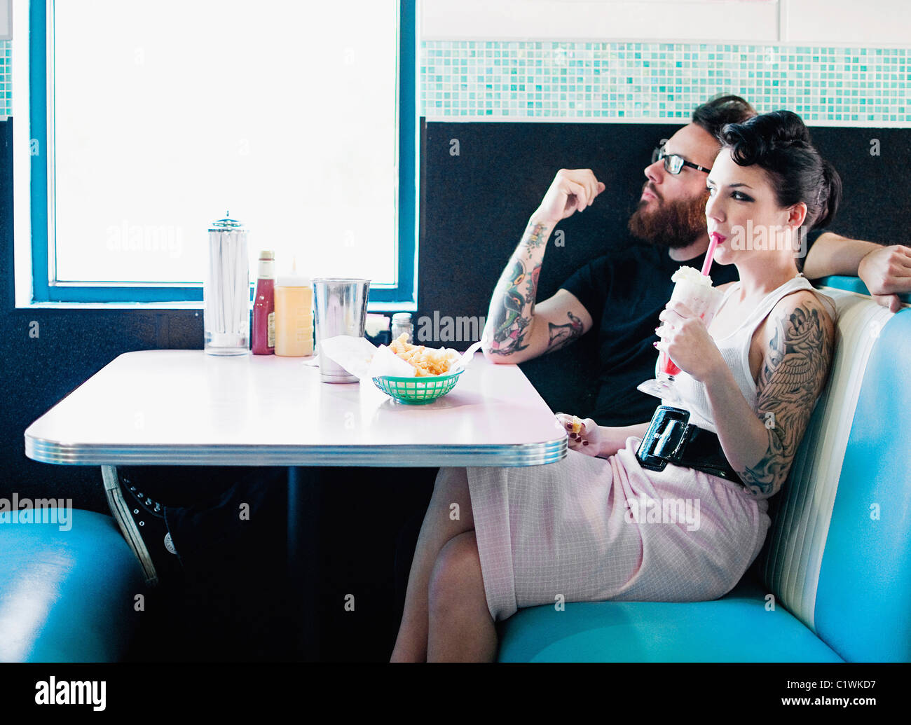 Couple having milkshake and snacks in a restaurant Stock Photo - Alamy