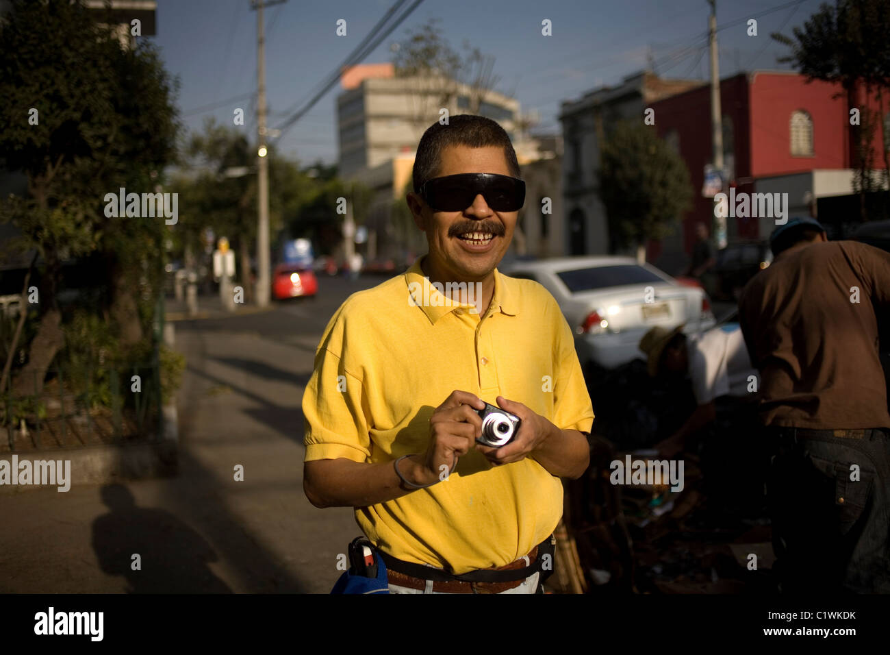 A blind photographer takes pictures during a photography workshop for ...