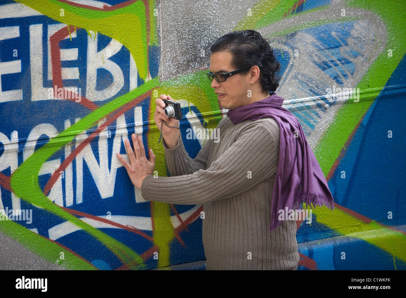 A visually impaired student touches a bus during a photography workshop ...