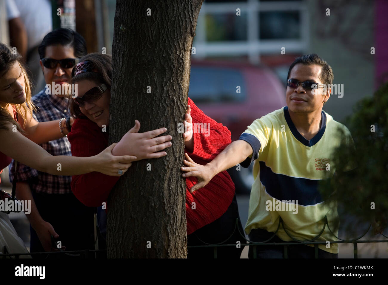 Blind students hug and touch a tree during a photography workshop for ...