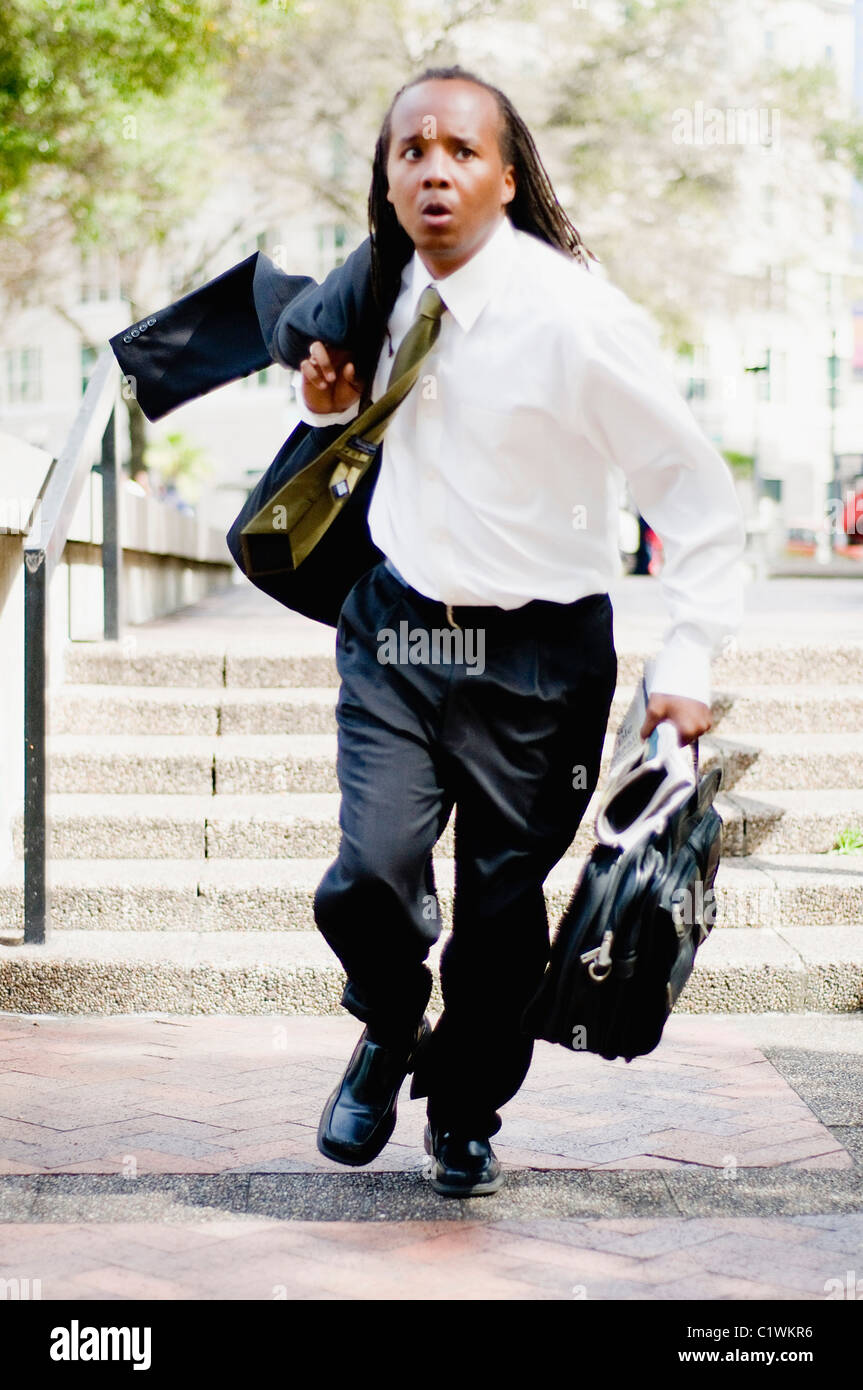 Businessman running on a street Stock Photo - Alamy