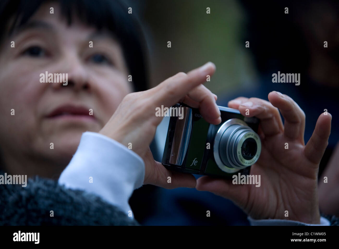 A blind female student touches a camera during a photography workshop ...