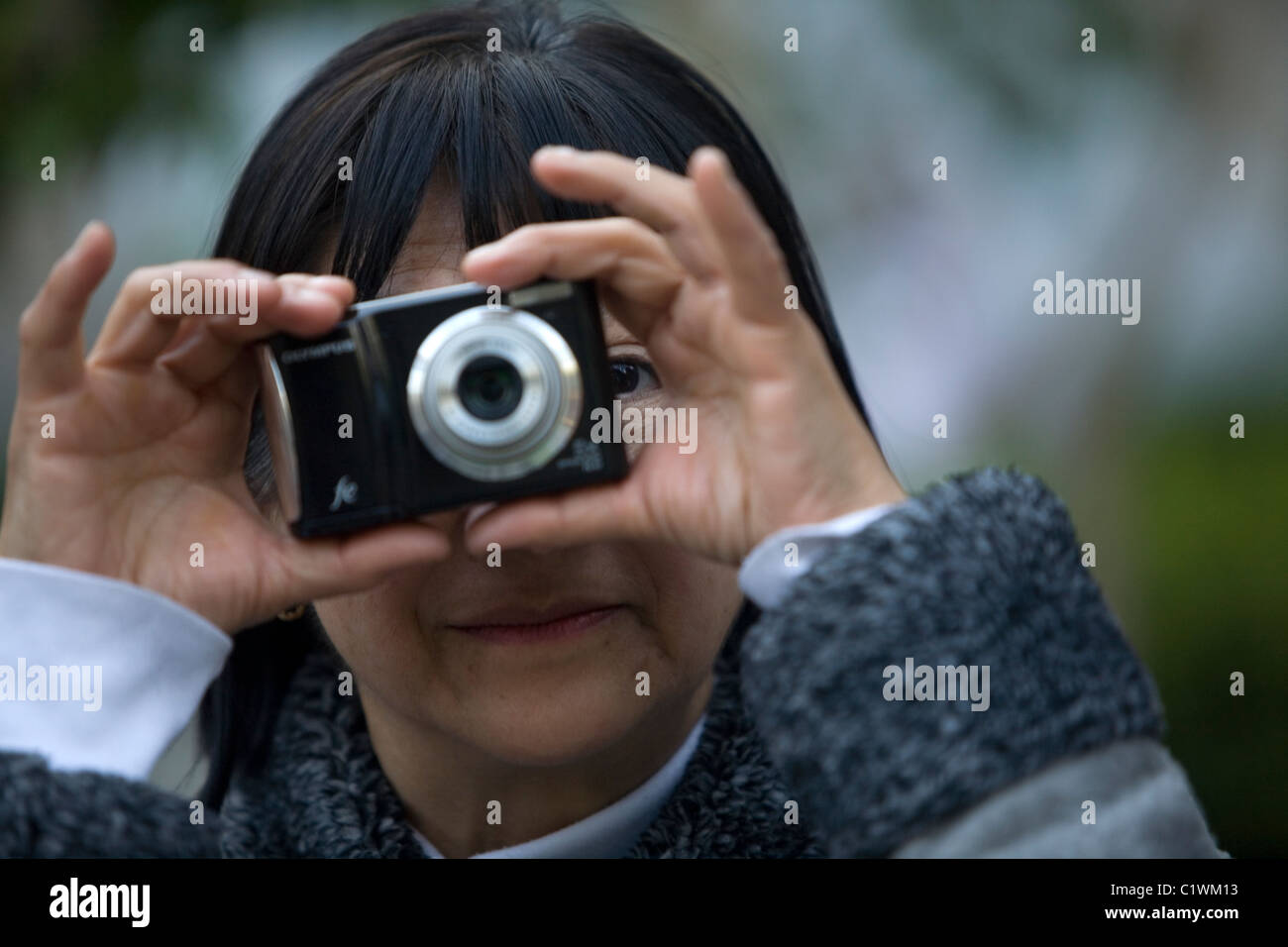 A blind student takes pictures during a photography workshop for the ...