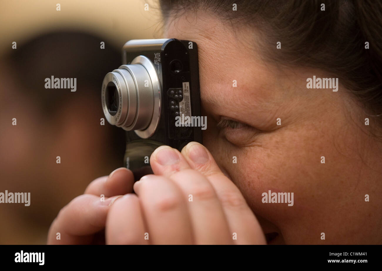 A blind female student takes a pictures during a photography workshop ...