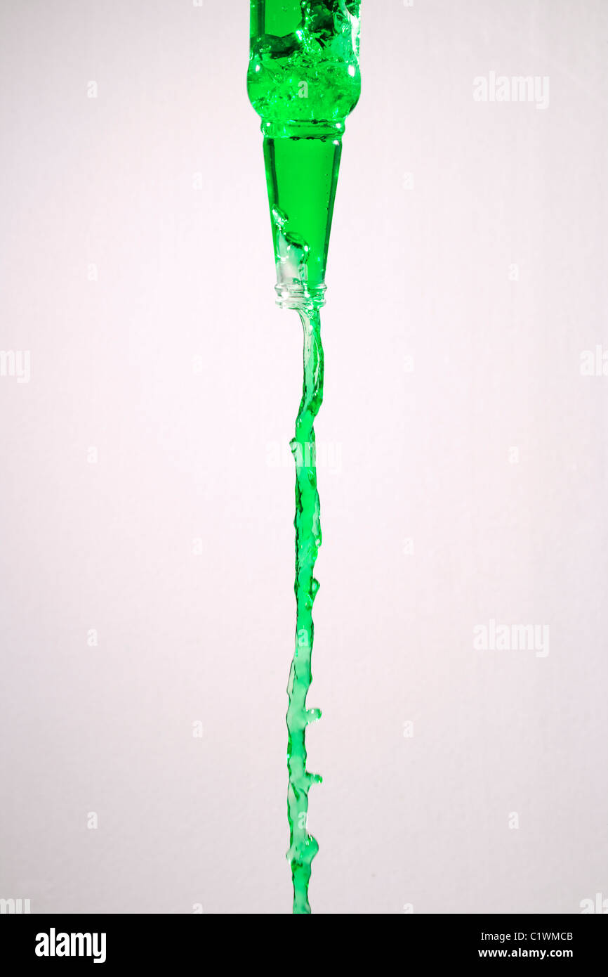 A stream of green liquid pouring out of a glass bottle Stock Photo - Alamy