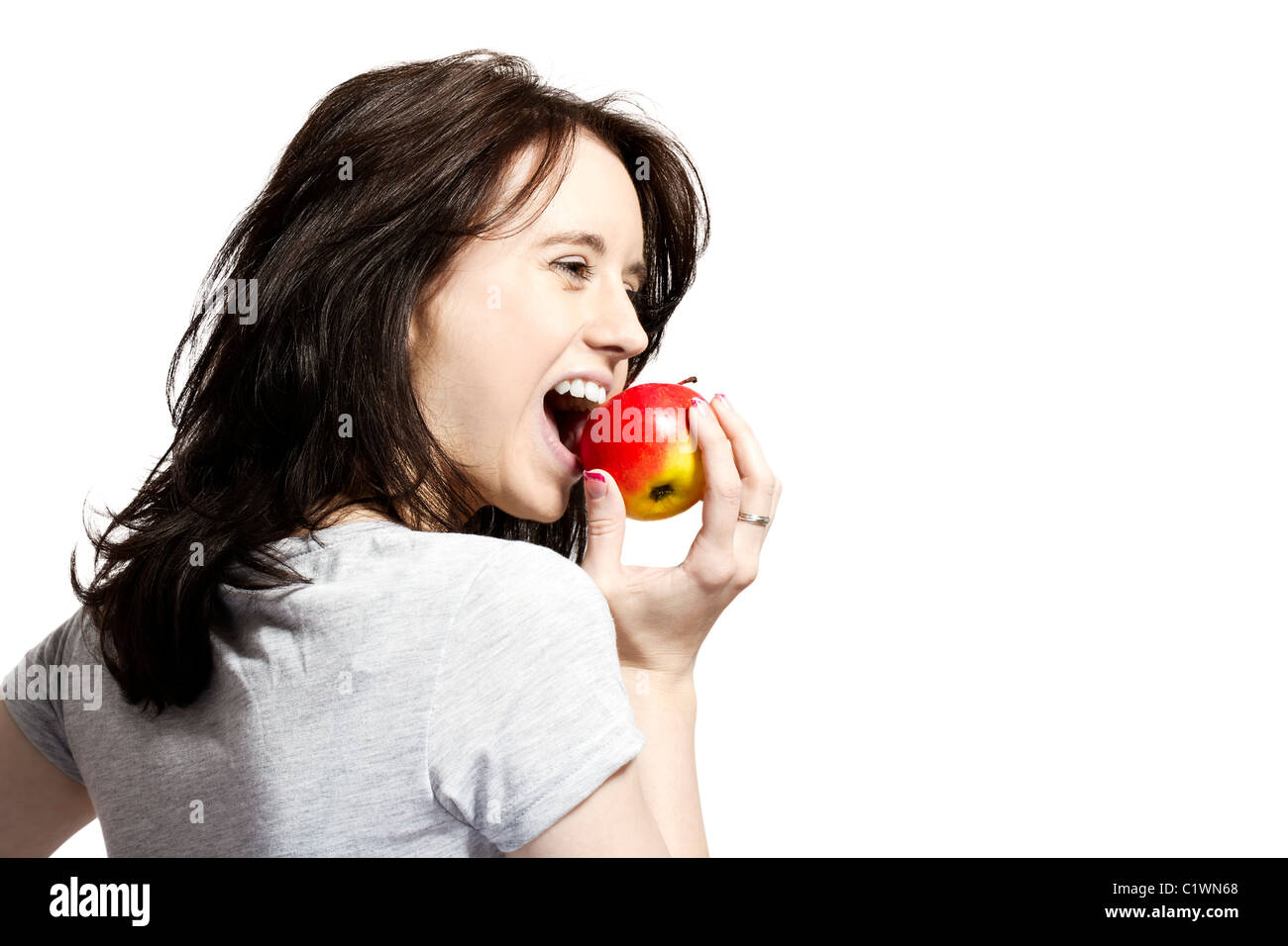 young happy woman eating red apple Stock Photo - Alamy