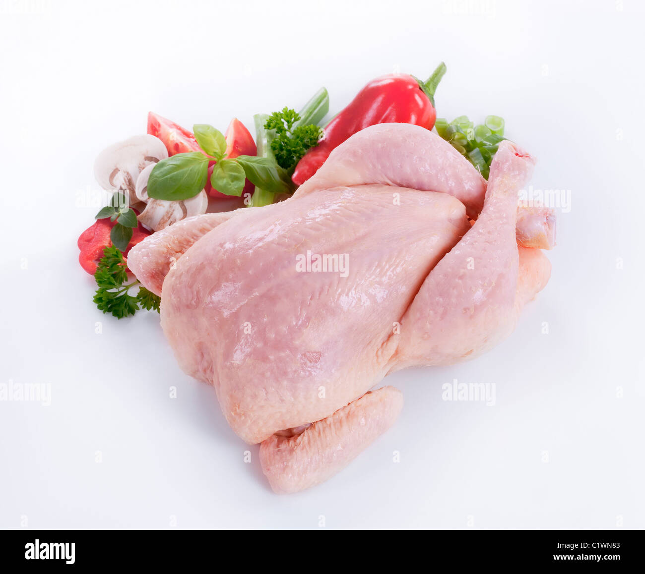 Raw chicken and fresh vegetables - studio Stock Photo - Alamy