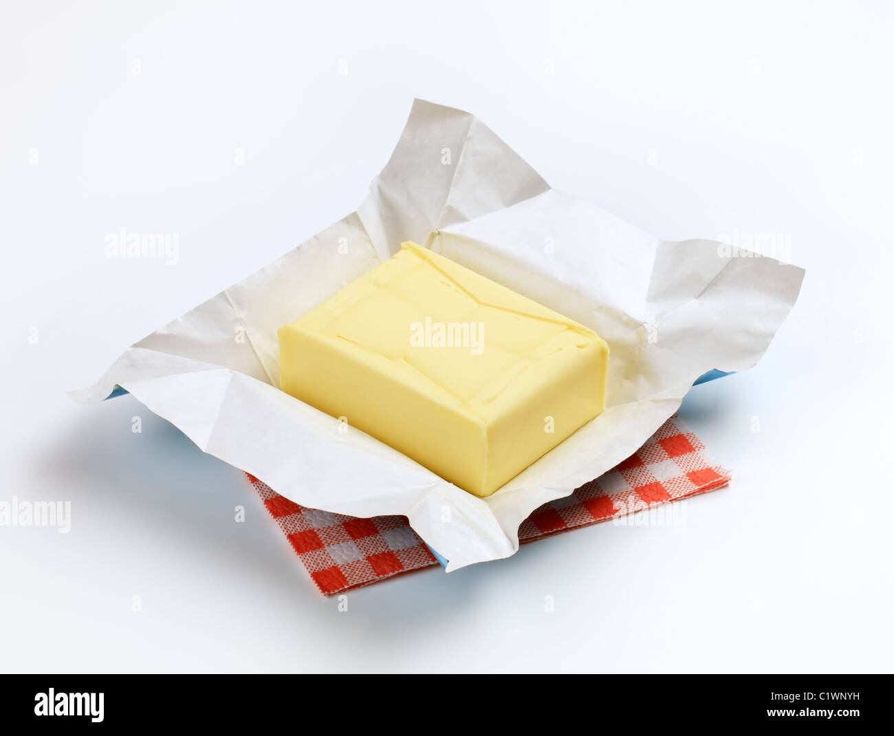 Block of fresh butter resting on a wrapper Stock Photo - Alamy