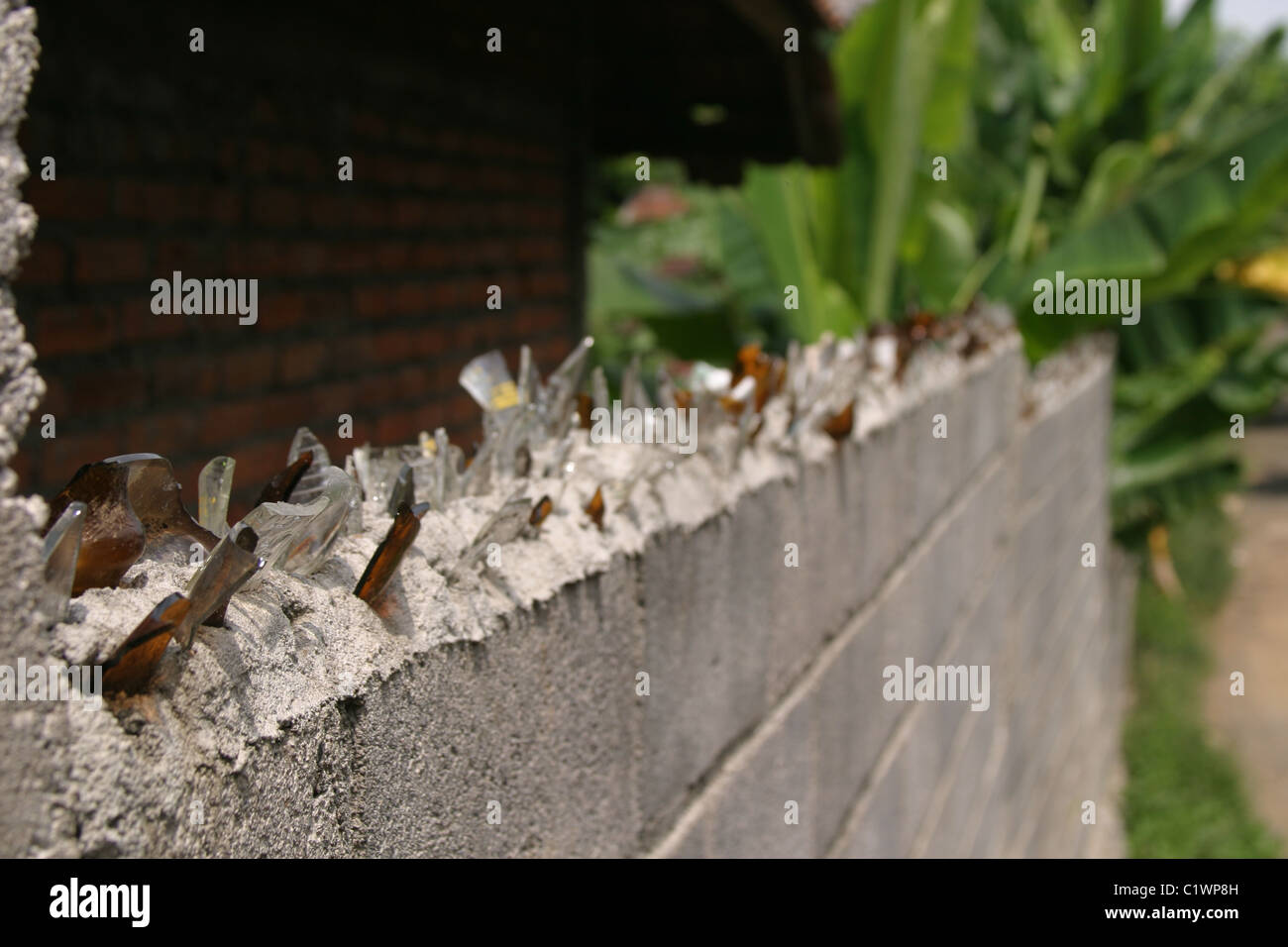 Broken glass embedded into the top of a concrete barrier Stock Photo ...