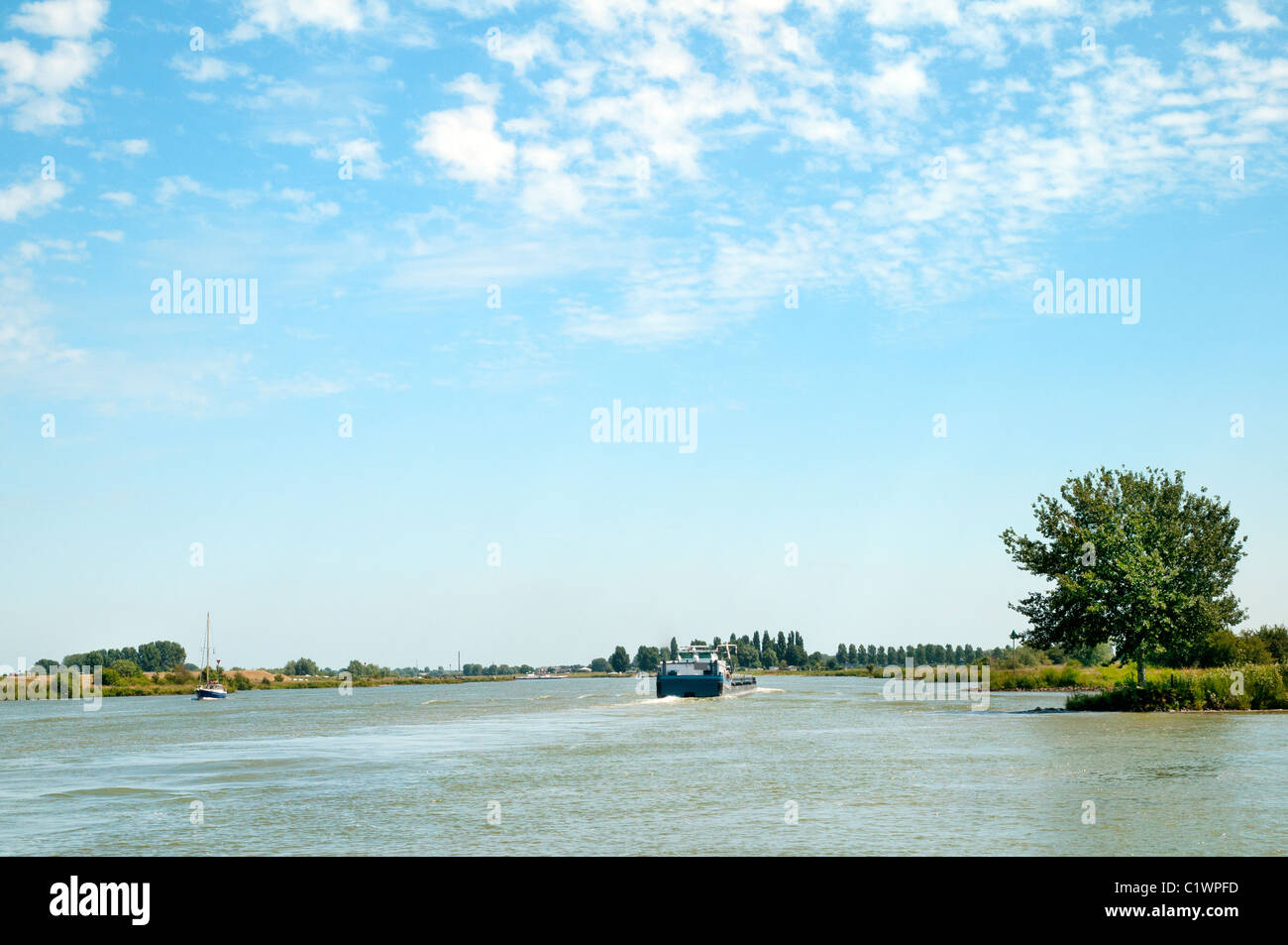 Landscape with river the Lek and cargo boat in Holland Stock Photo - Alamy