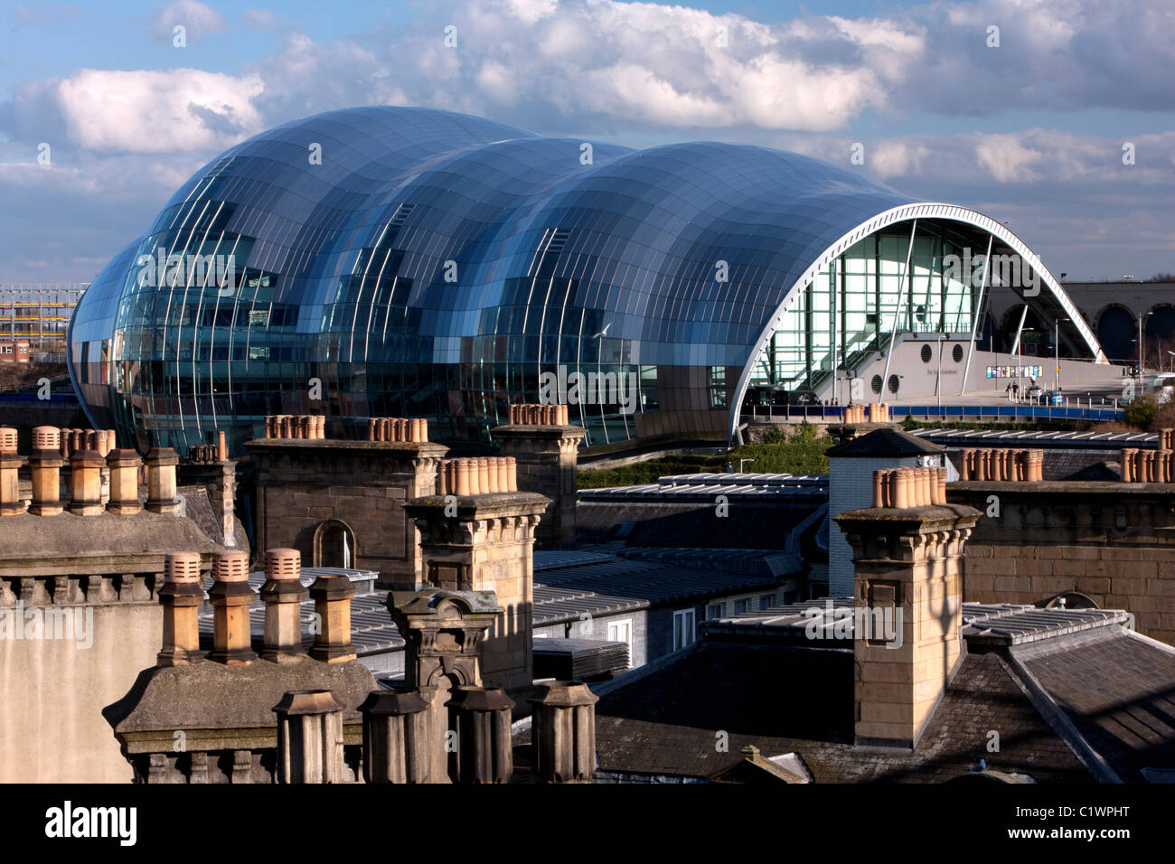Daytime view of The Sage Gateshead, with rooftops and chimneys in the ...